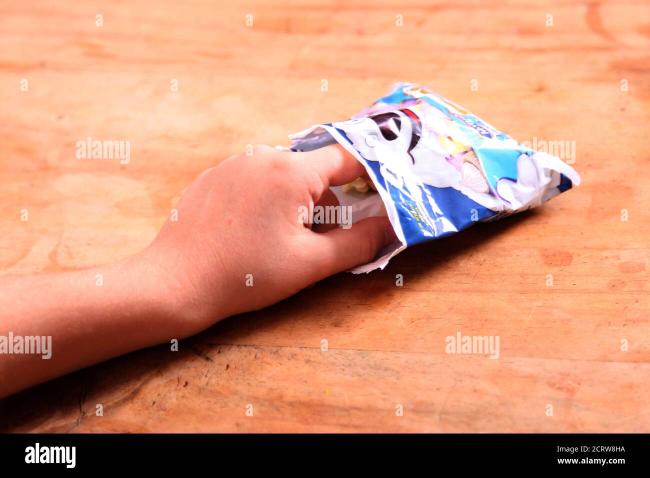 A child takes a McVitie's Iced Gem biscuit from packet Stock Photo - Alamy