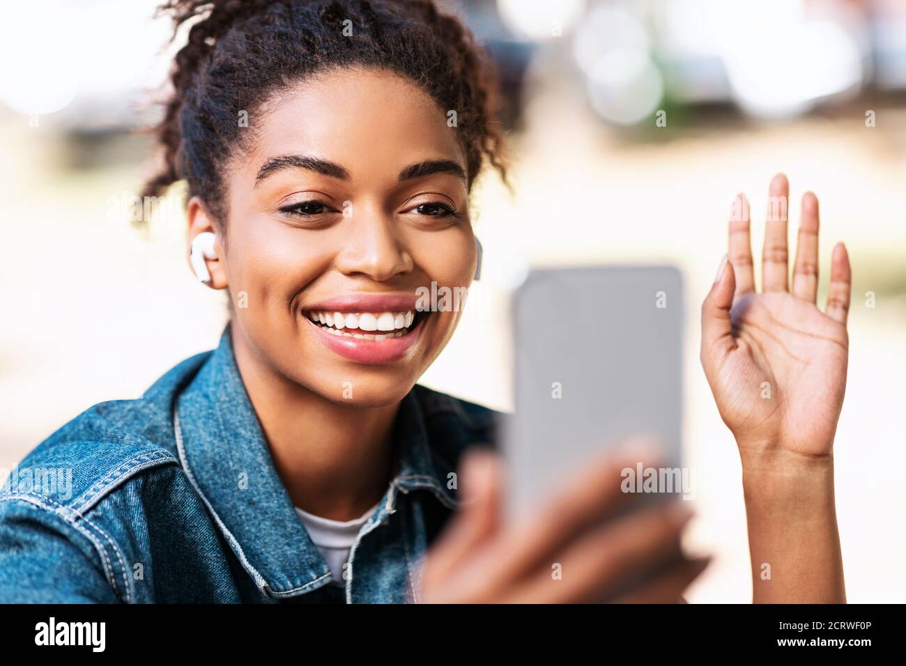 African Woman Making Video Call Using Phone Waving Hello Outdoors Stock ...