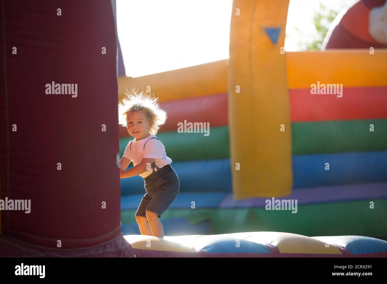 Children, boys, playing jumping on colorful trampoline in park Stock ...