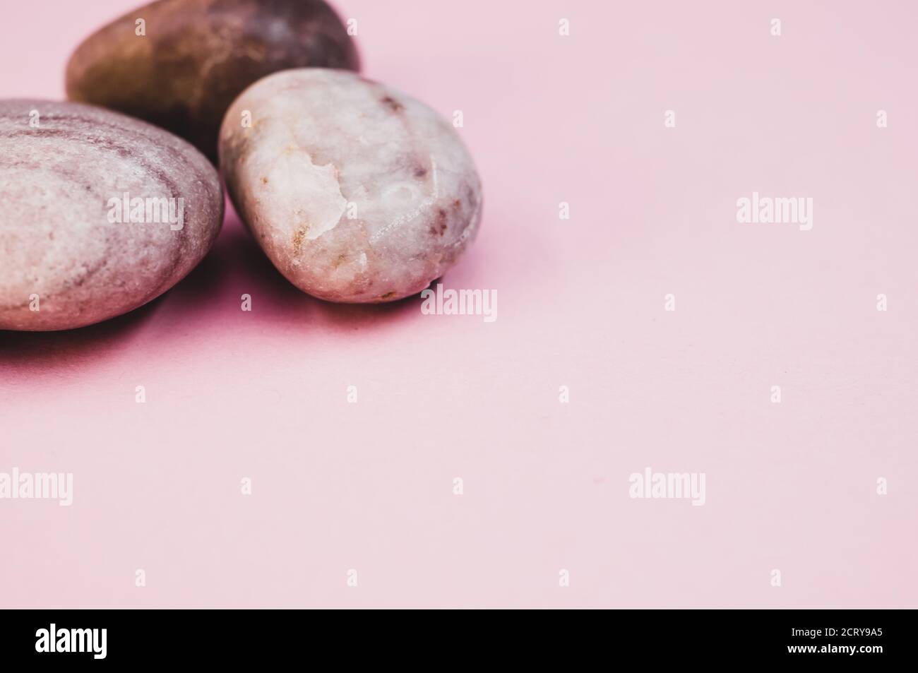 Closeup shot of pebbles isolated on a pink background Stock Photo - Alamy