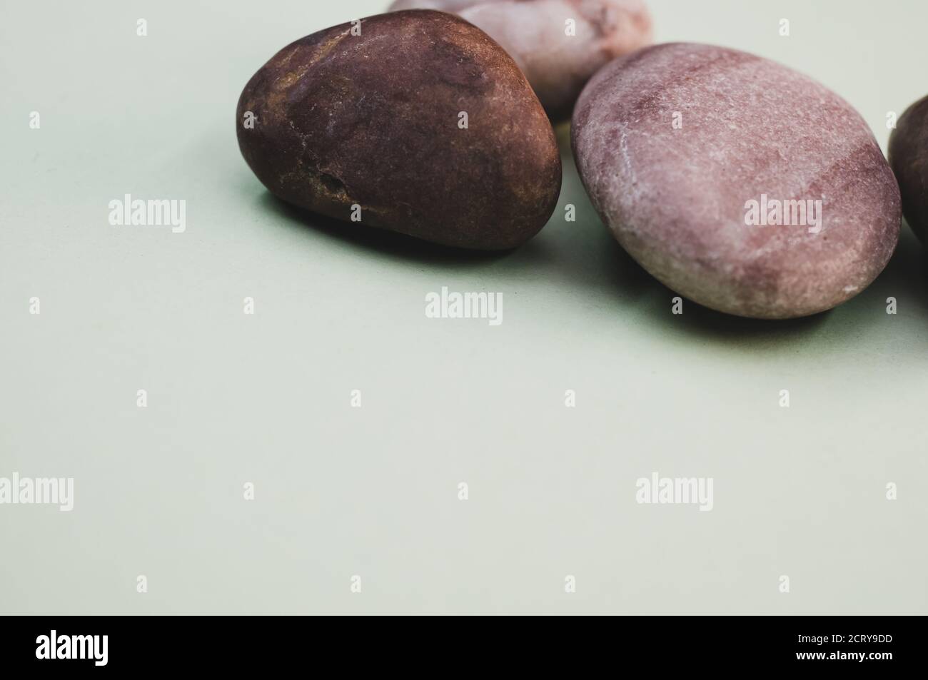 Closeup shot of pebbles isolated on a blue background Stock Photo - Alamy
