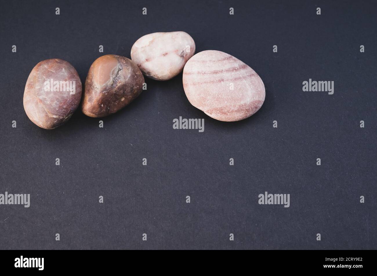 Top view of pebbles isolated on a black background Stock Photo - Alamy