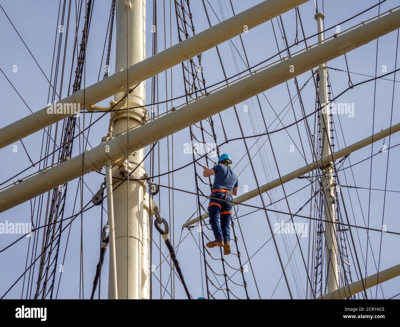 in the rigging of a sailing ship Climbing a man Stock Photo - Alamy