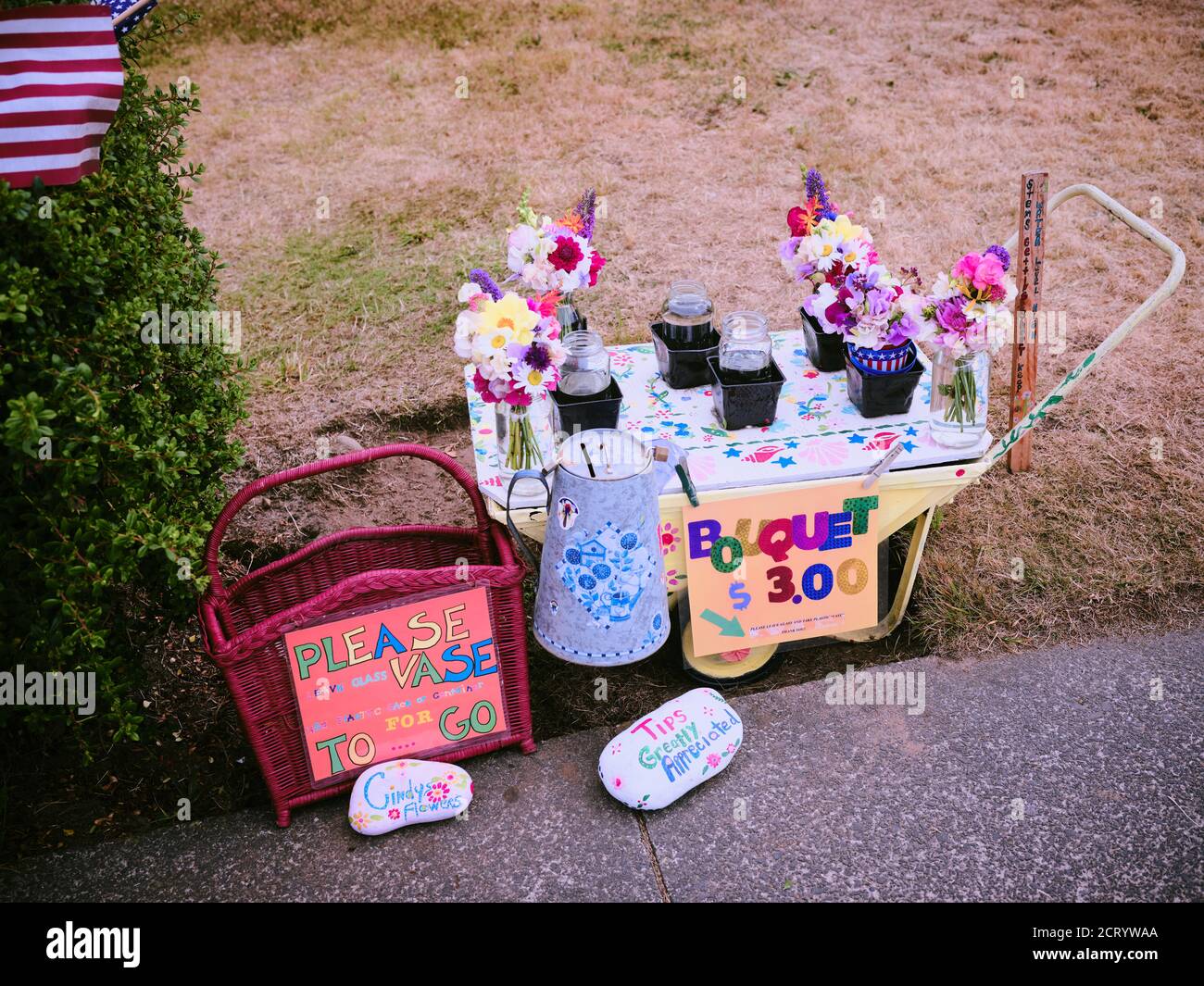 A sidewalk flower stand sells bouquets of fresh cut flowers Stock Photo ...