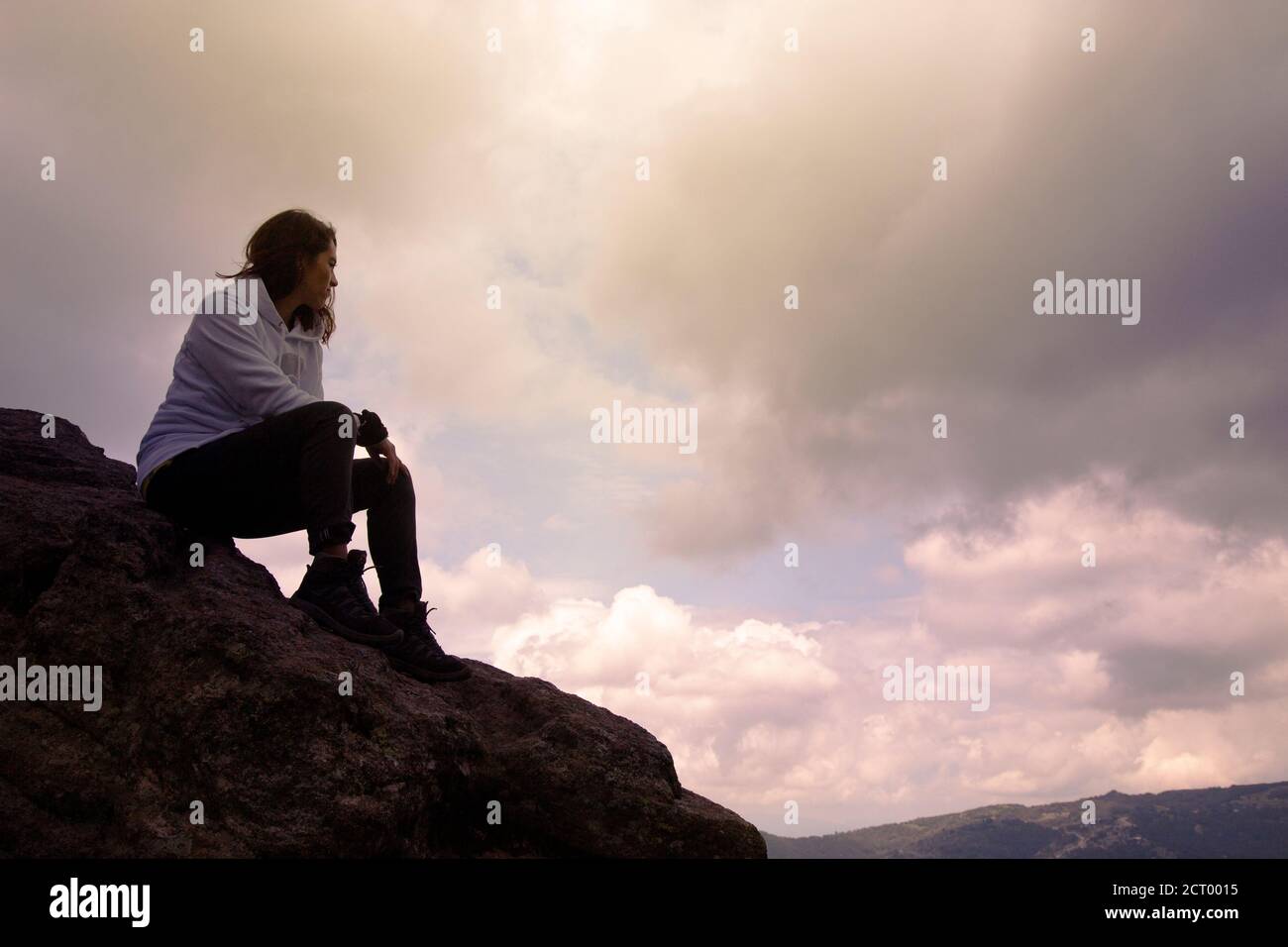 Silhouette woman sitting on rocks hi-res stock photography and images ...