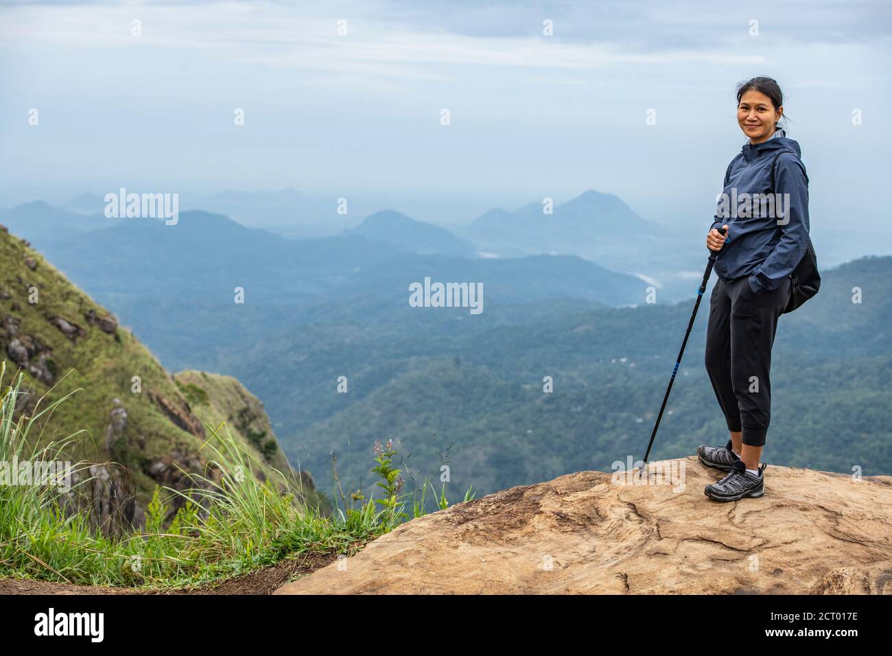 woman standing on top of Adam's Peak close to Ella in Sri Lanka Stock ...