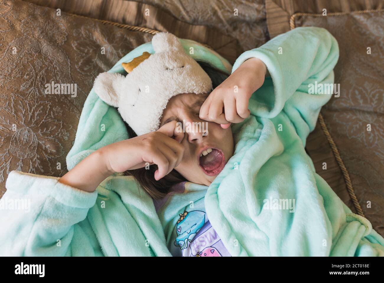 Cute little girl waking up and yawning Stock Photo - Alamy