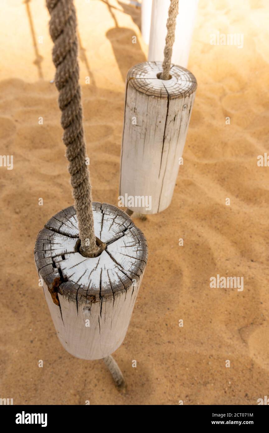 Vertical shot of two sawed tree stumps on a rope Stock Photo - Alamy