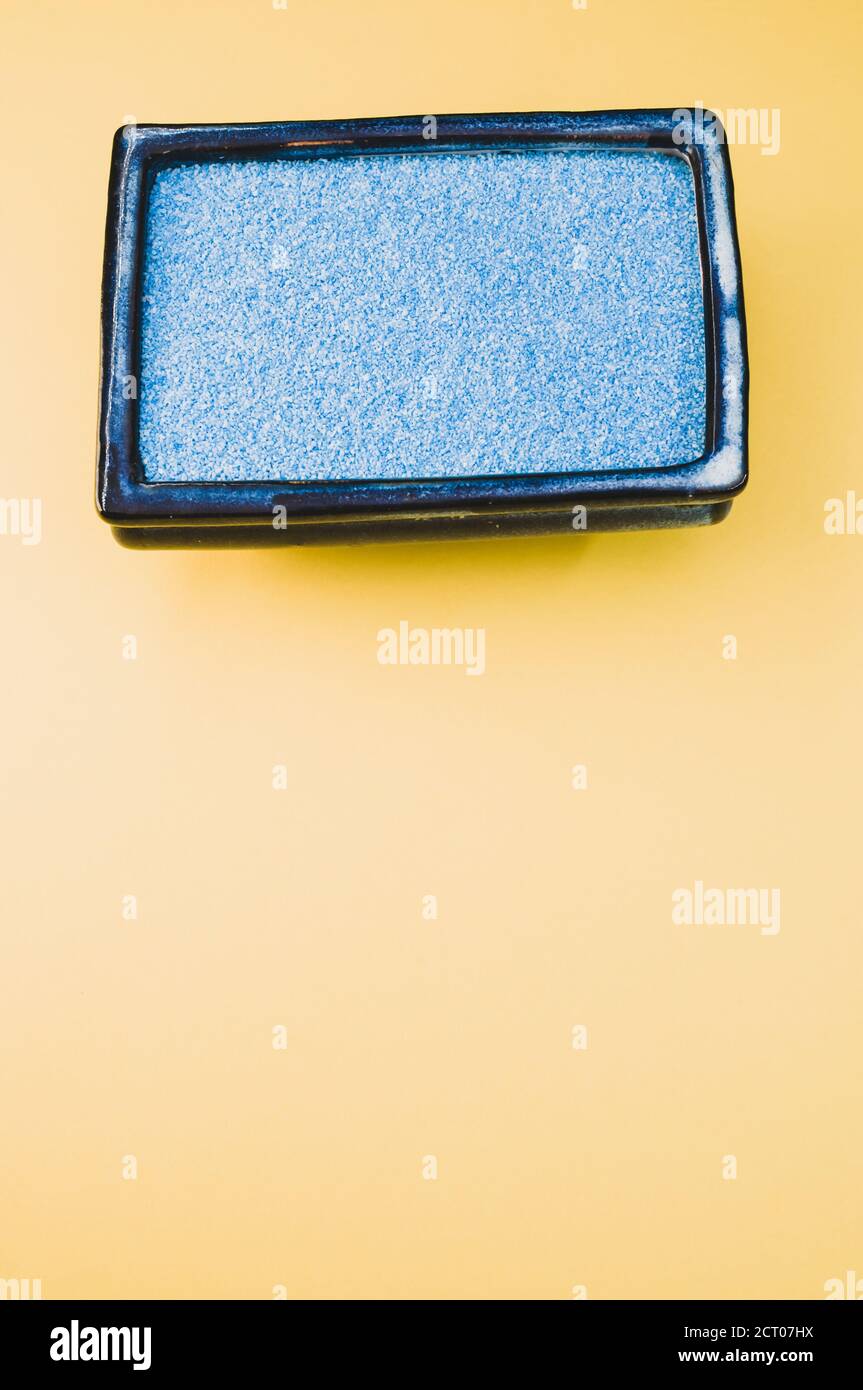 Vertical shot of a rectangular box filled with small blue rocks on ...