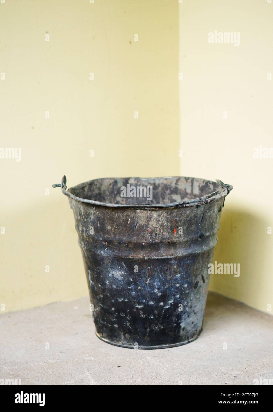 Old rusty bucket by a wall Stock Photo - Alamy