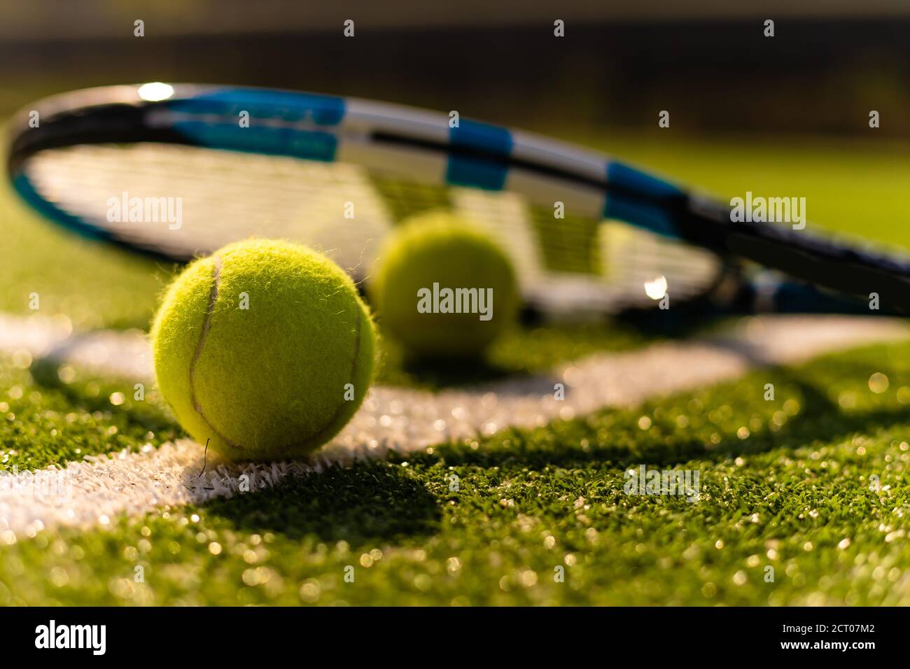 View of empty lawn tennis court with tennis ball Stock Photo - Alamy