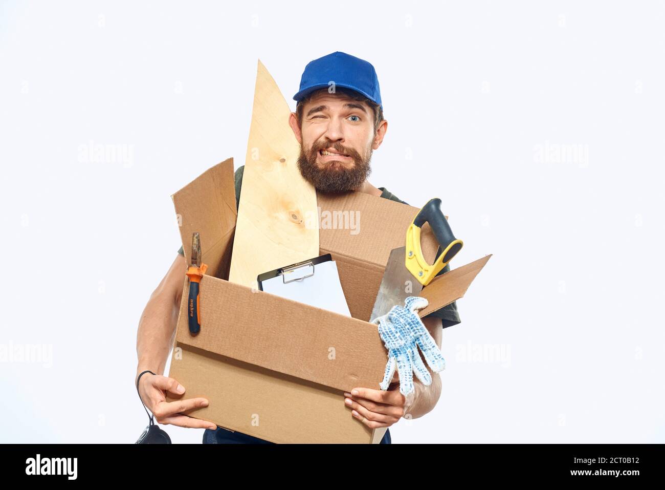 Worker man in uniform with a box in his hands tools delivery service ...