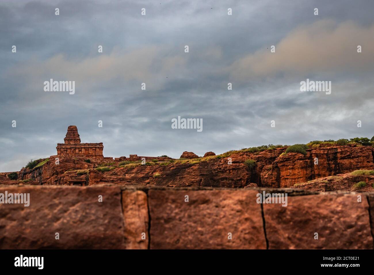 mountain top temple with flat sky at morning image is taken at badami ...