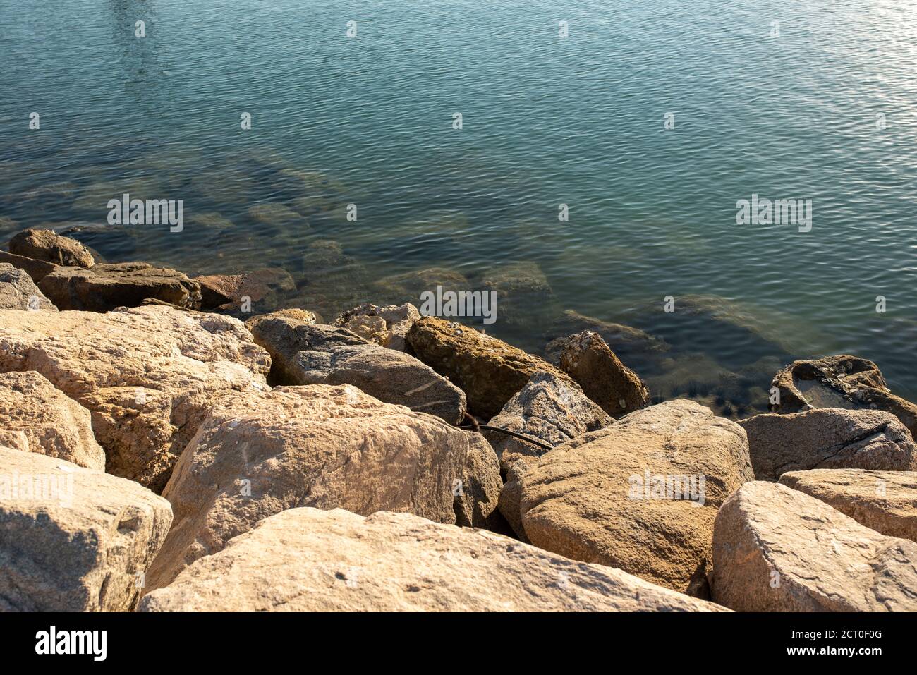 The sunrise over the sea with green-blue clear water breaking over ...