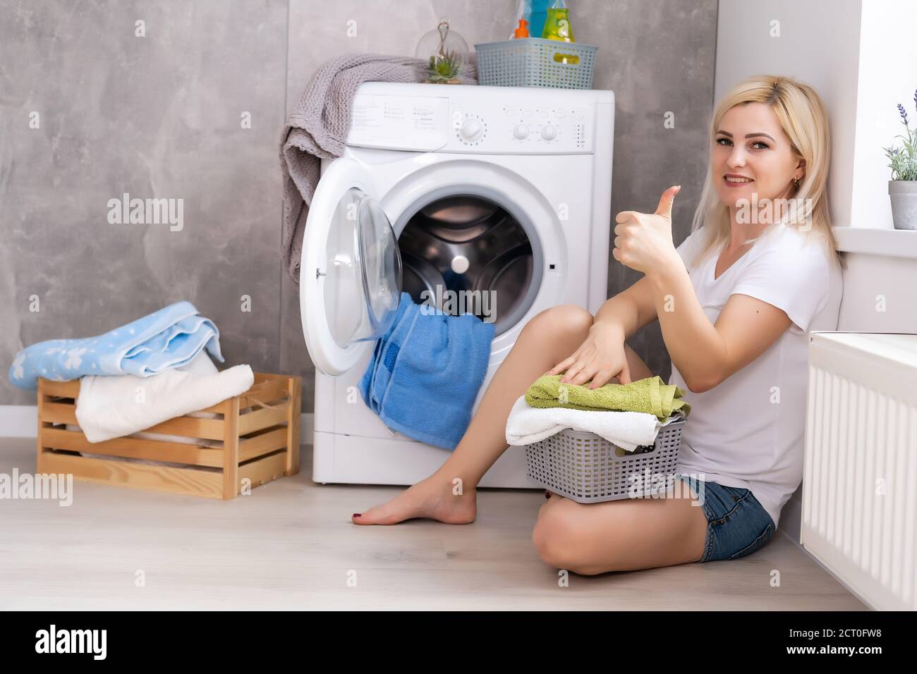 pretty smiling girl in the laundry room Stock Photo - Alamy