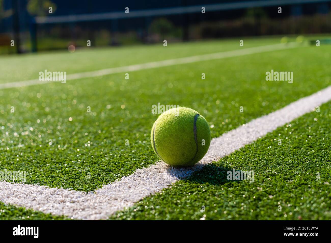 View of empty lawn tennis court with tennis ball Stock Photo - Alamy
