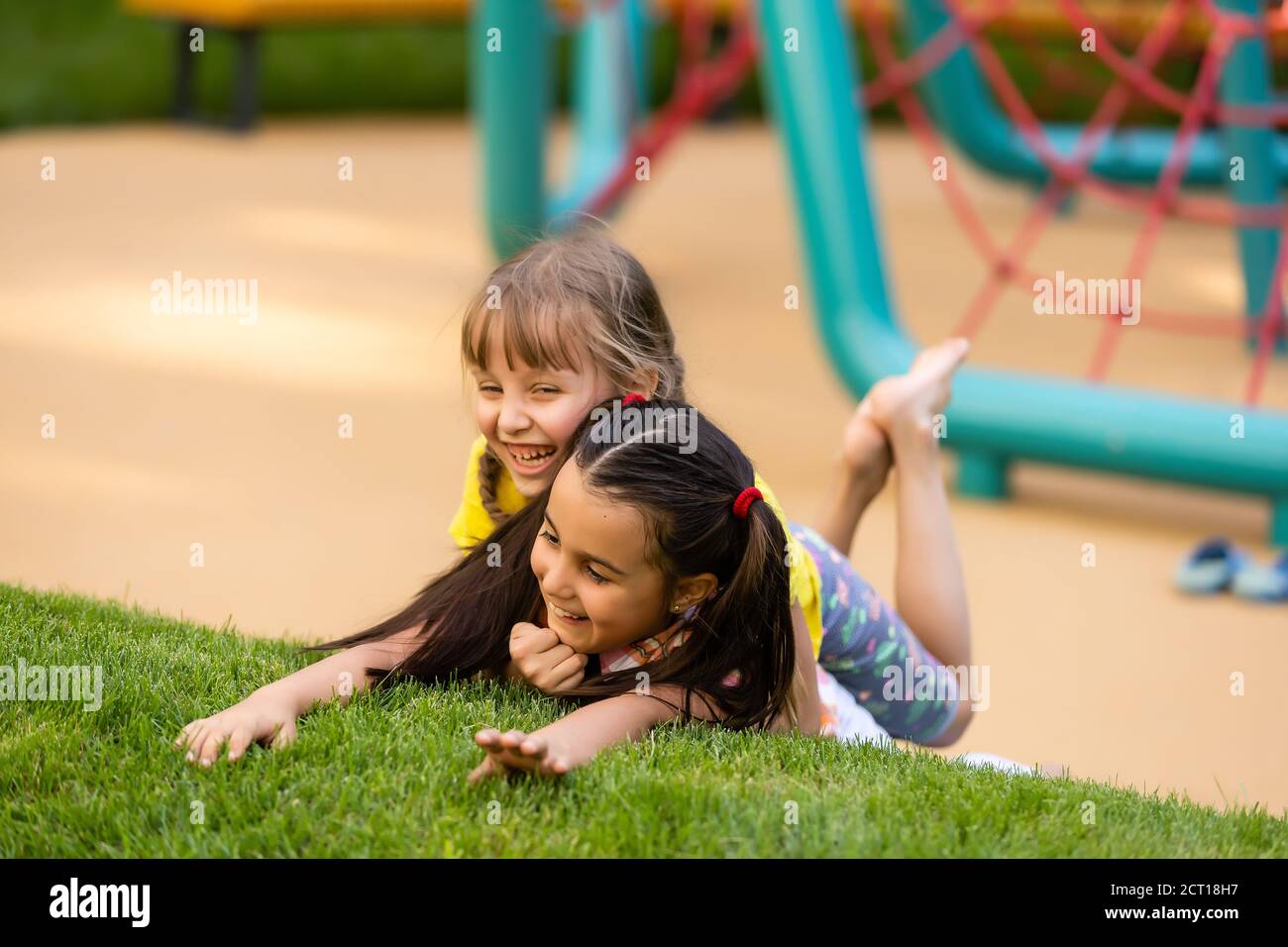 Portrait of two little girls sisters fighting on home backyard. Friends ...