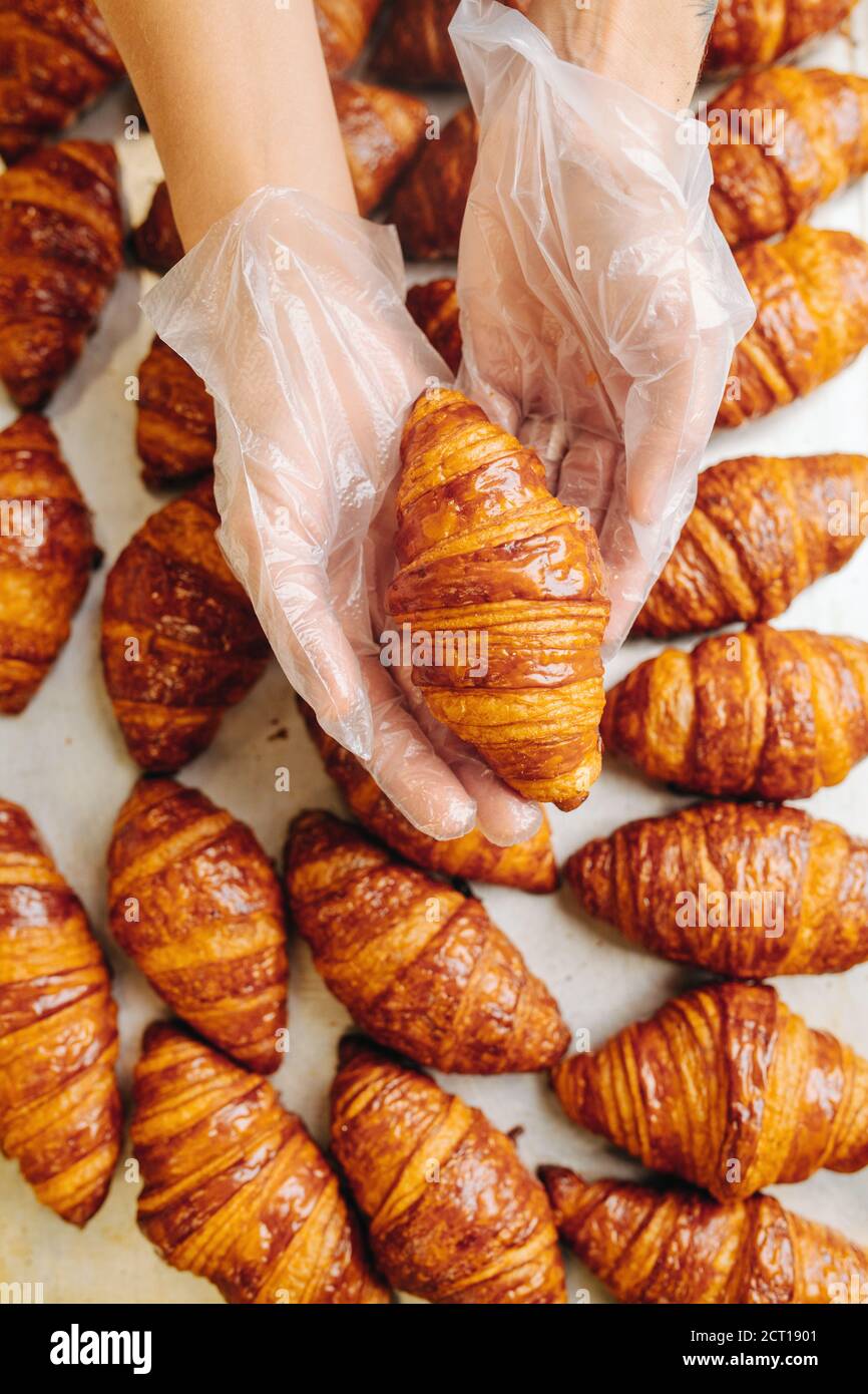 Hands taking croissants from table hi-res stock photography and images ...