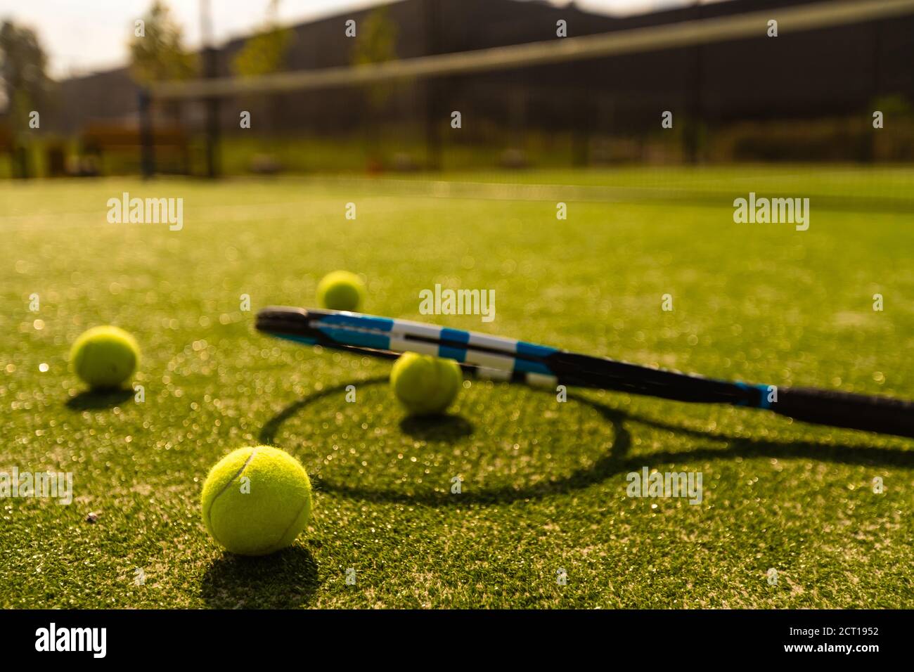 Tennis Racket on empty tennis grass court Stock Photo - Alamy