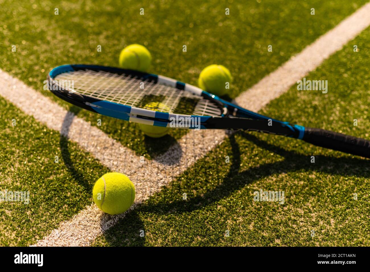 Tennis Racket on empty tennis grass court Stock Photo - Alamy