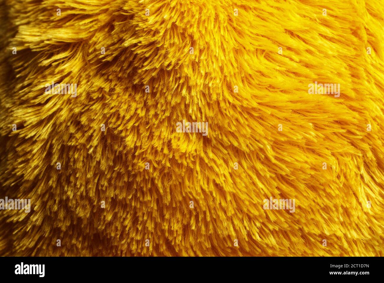 Dark artificial yellow fur background Stock Photo - Alamy