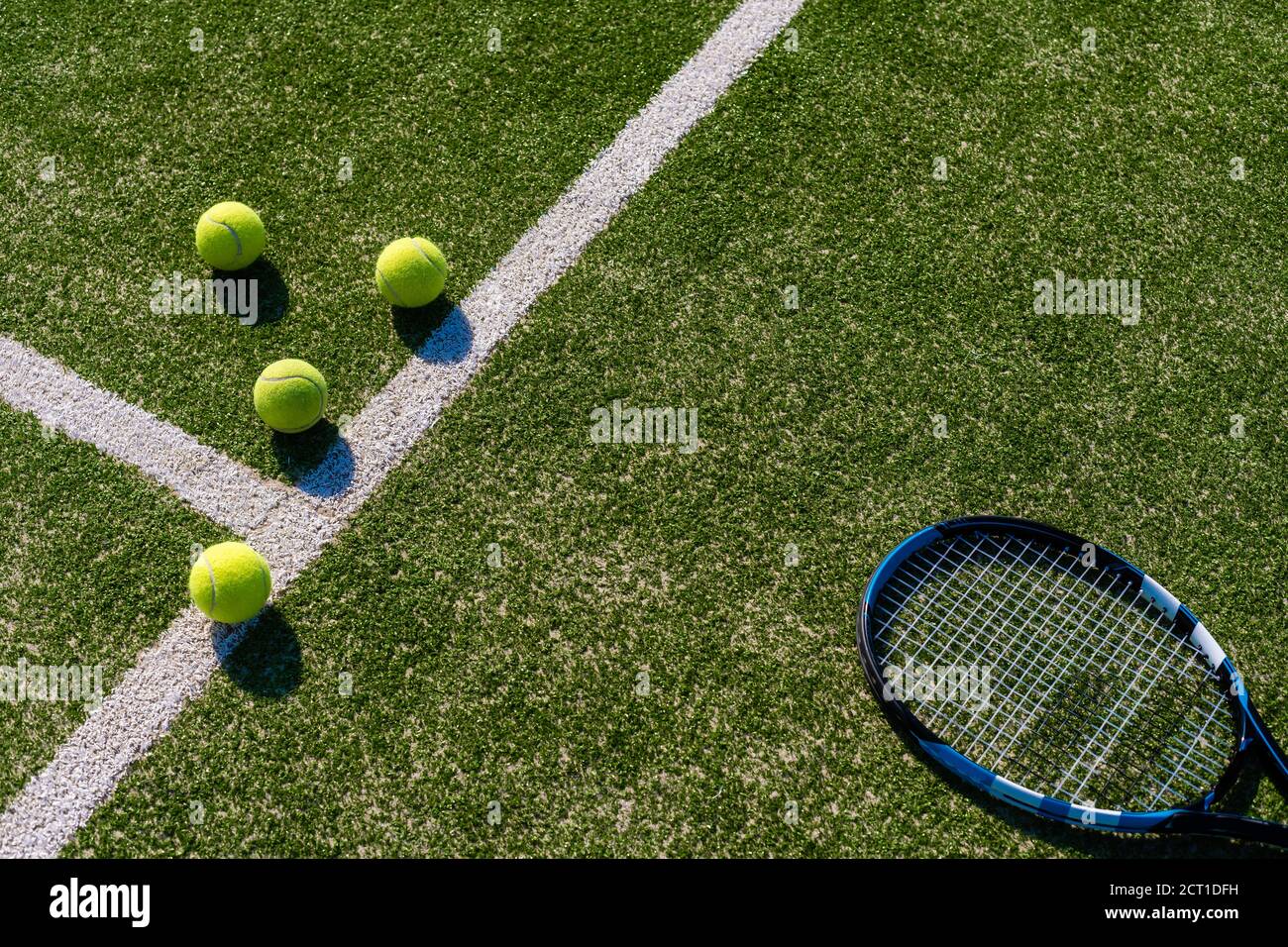 View of empty lawn tennis court with tennis ball Stock Photo - Alamy