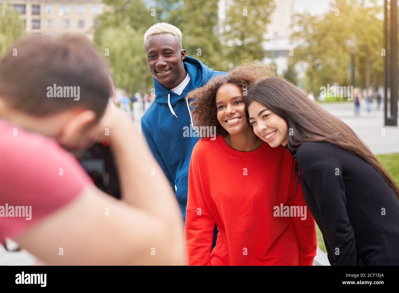 Multi ethnic friends outdoor on photo shooting looking at camera ...