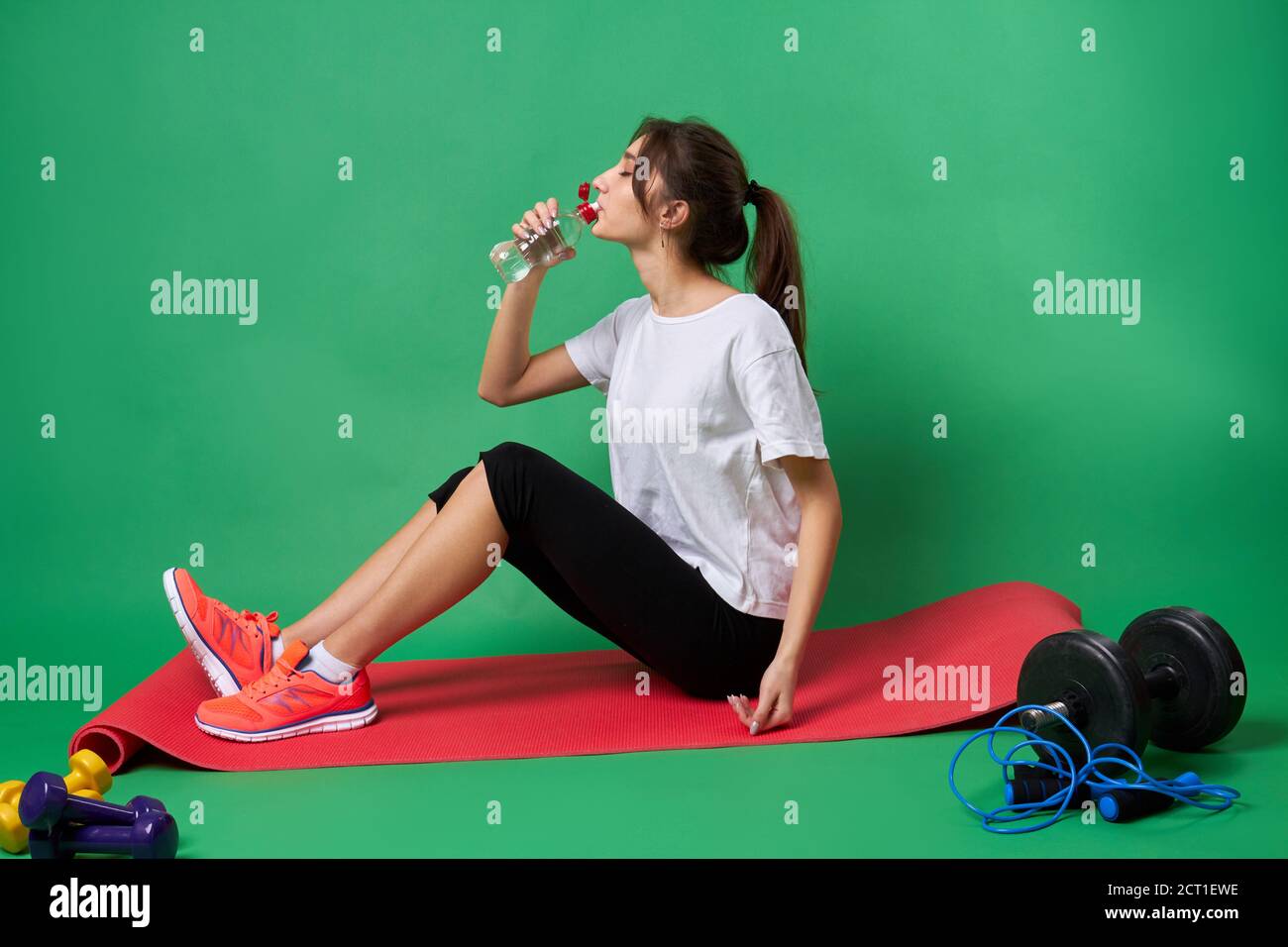 Woman's drinking water during work out exercises Stock Photo - Alamy
