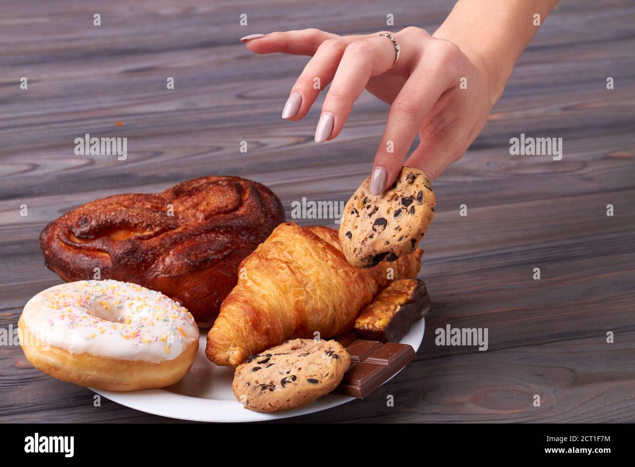 Hand is taking a tasty cookie Stock Photo - Alamy