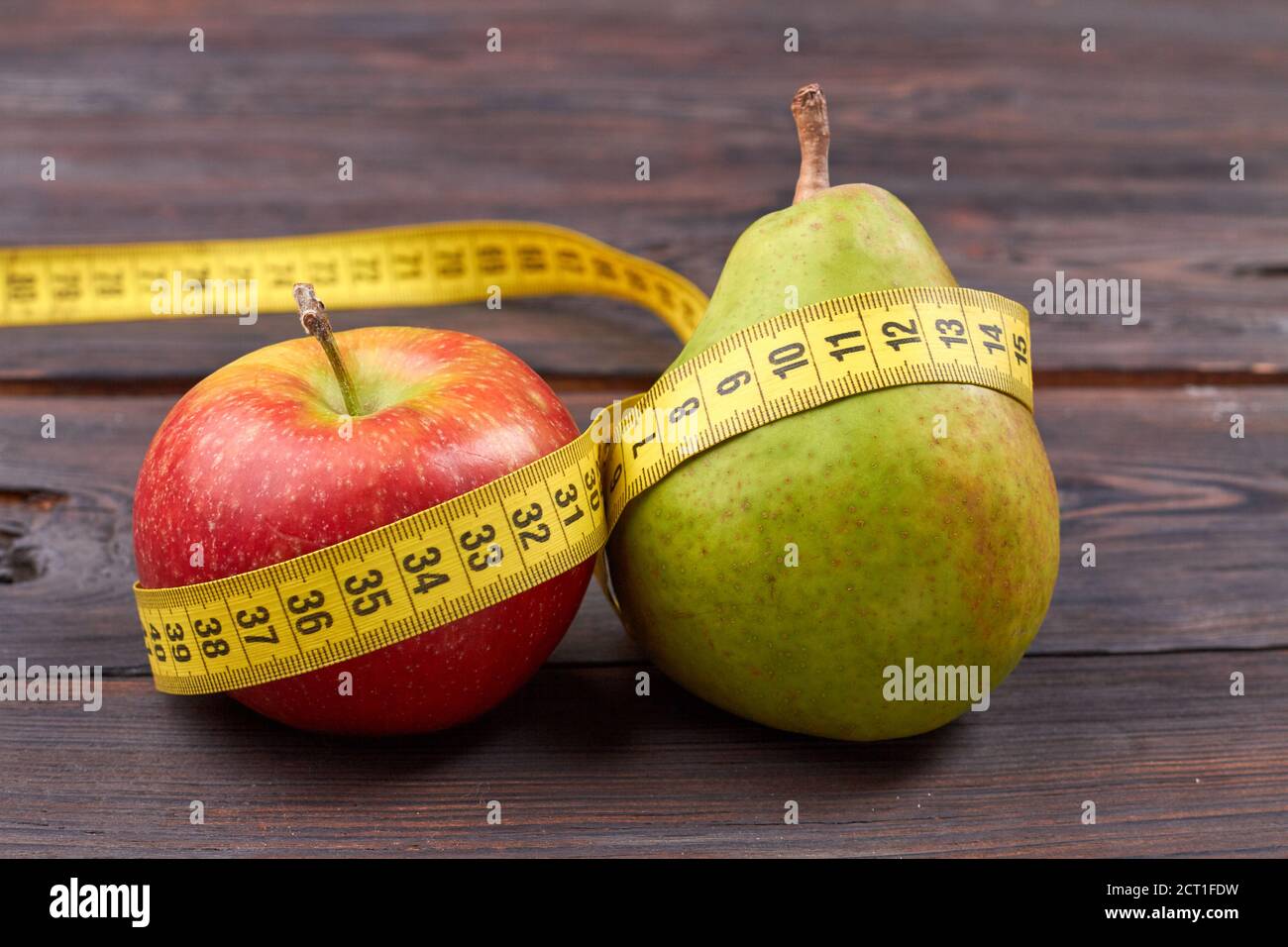 Fresh pear and apple with measure tape Stock Photo - Alamy