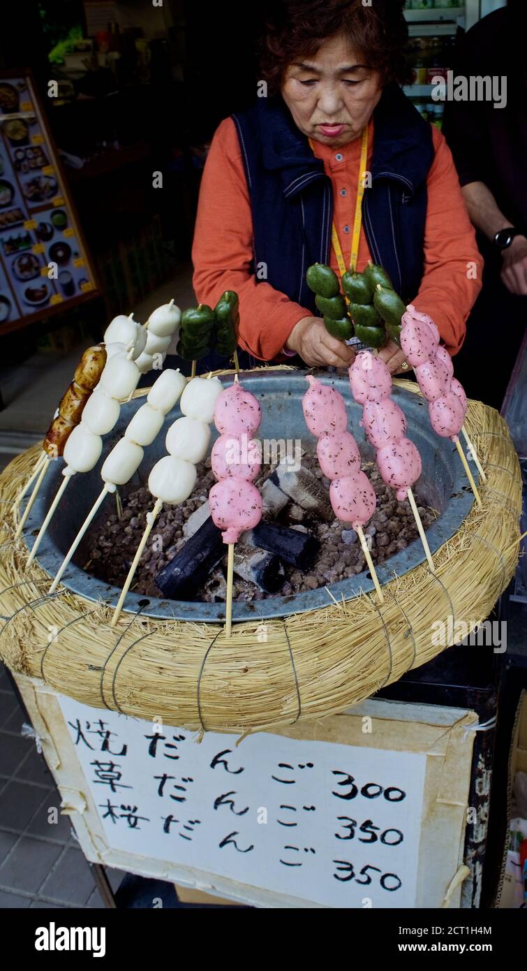 Japanese woman selling is a Dango (Japanese dumpling and sweet made ...