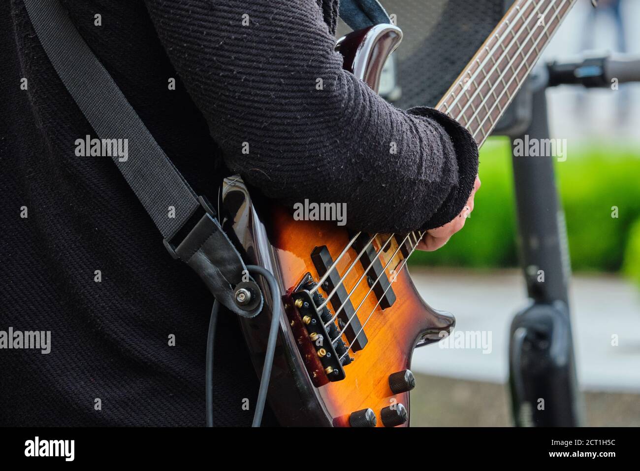 Person uses a guitar playing music on the street Stock Photo - Alamy