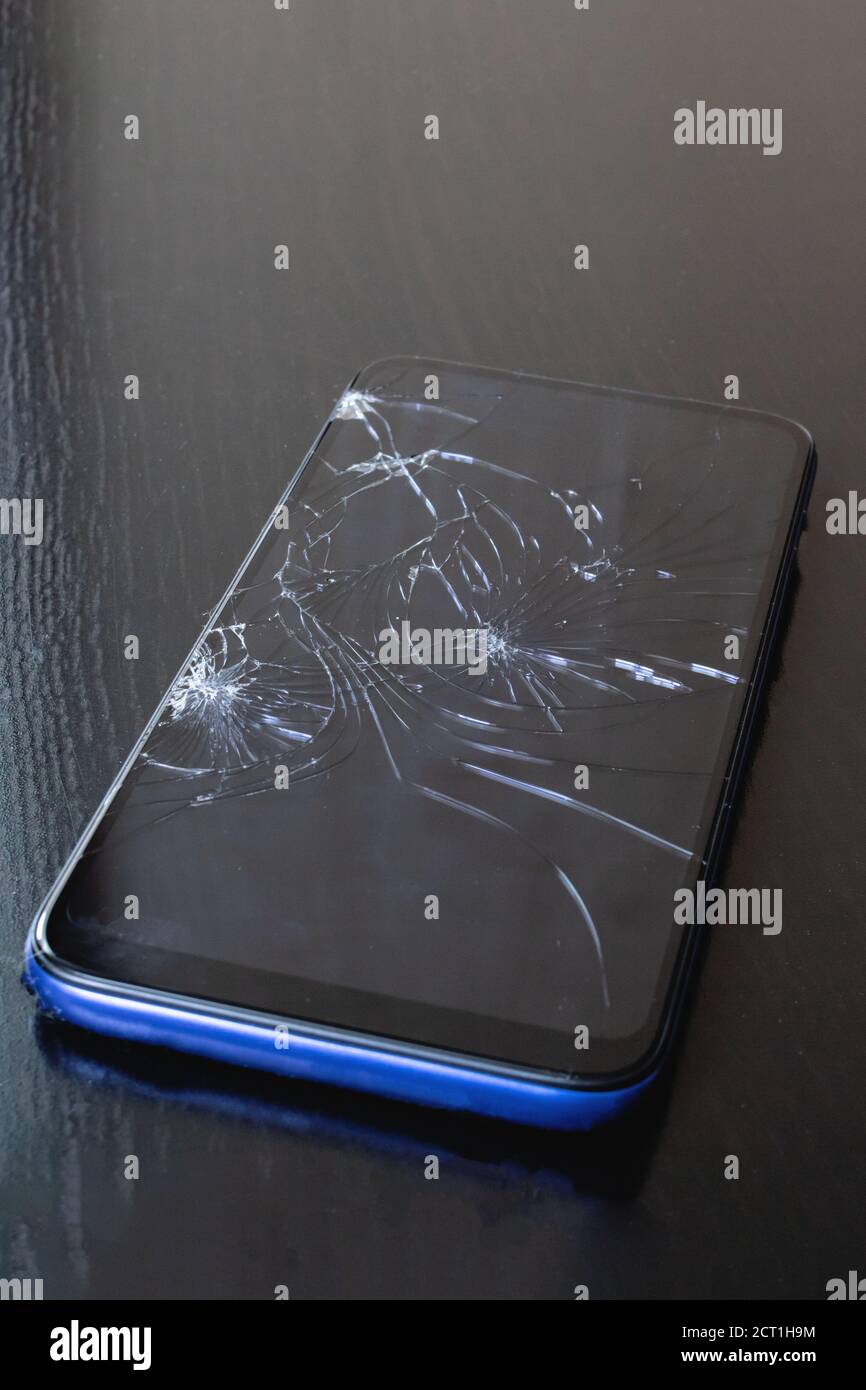 Broken mobile phone display, cracks close up Stock Photo - Alamy