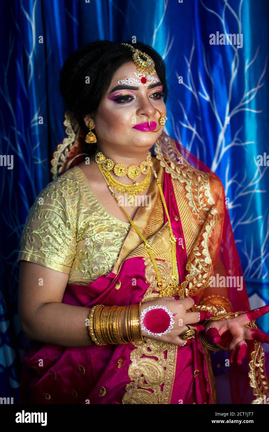 Portrait of a cute Indian model in Bridal look with heavy gold jewelry ...