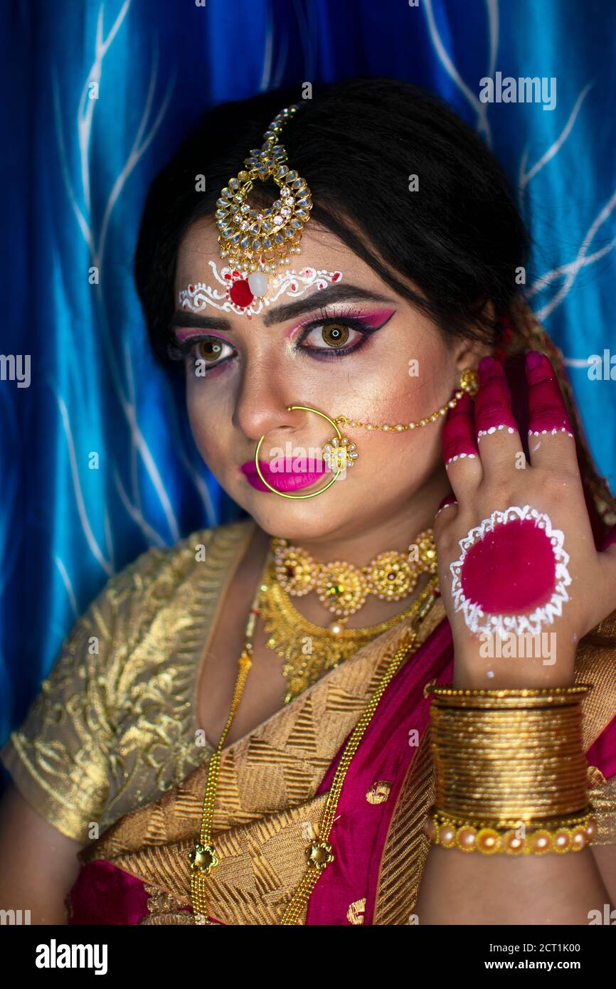 Portrait of a cute Indian model in Bridal look with heavy gold jewelry ...