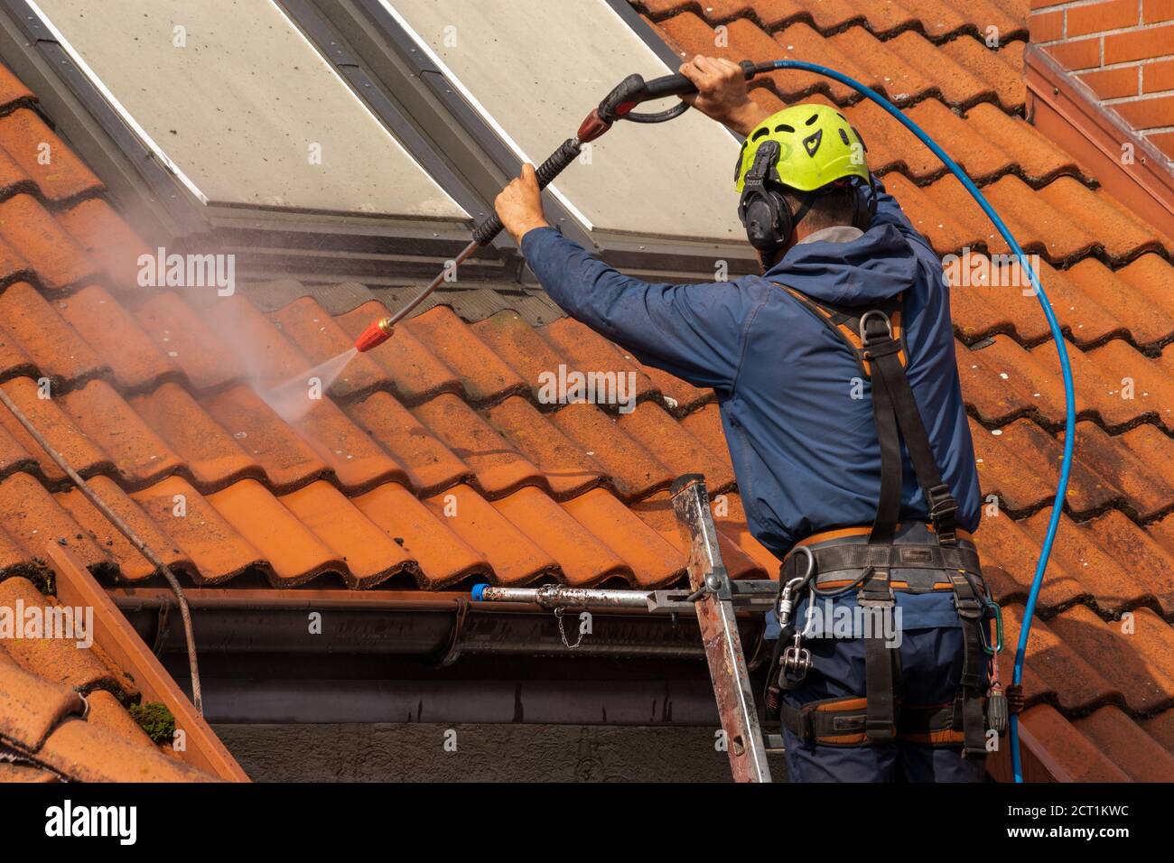 worker washing the roof with pressurized water Stock Photo - Alamy
