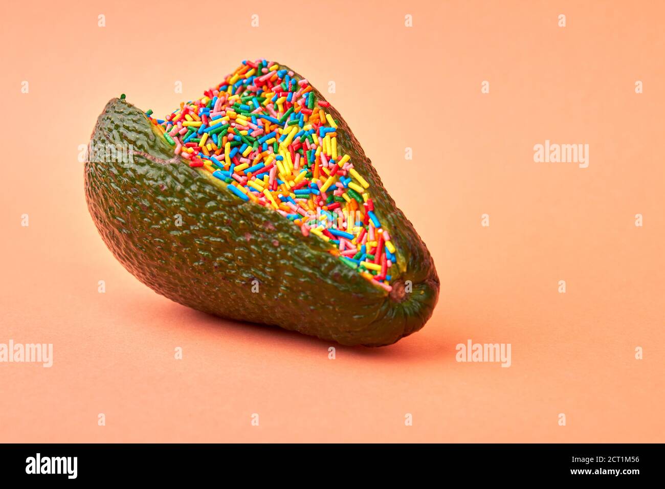 Avocado filling with sweet candy sprinklers Stock Photo - Alamy