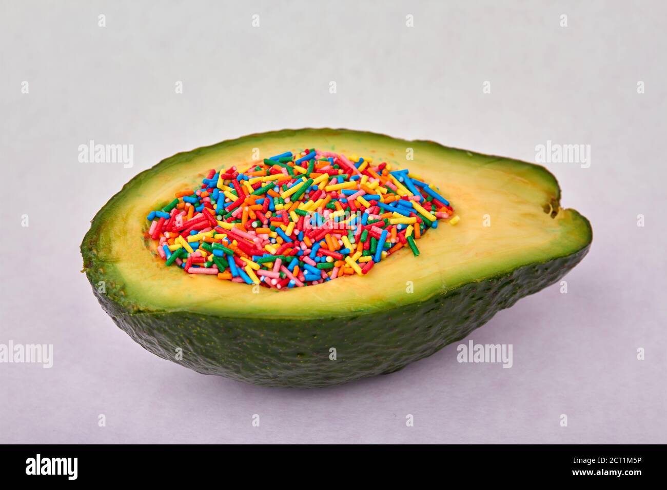 Close up avocado covered with sweet sprinklers Stock Photo - Alamy