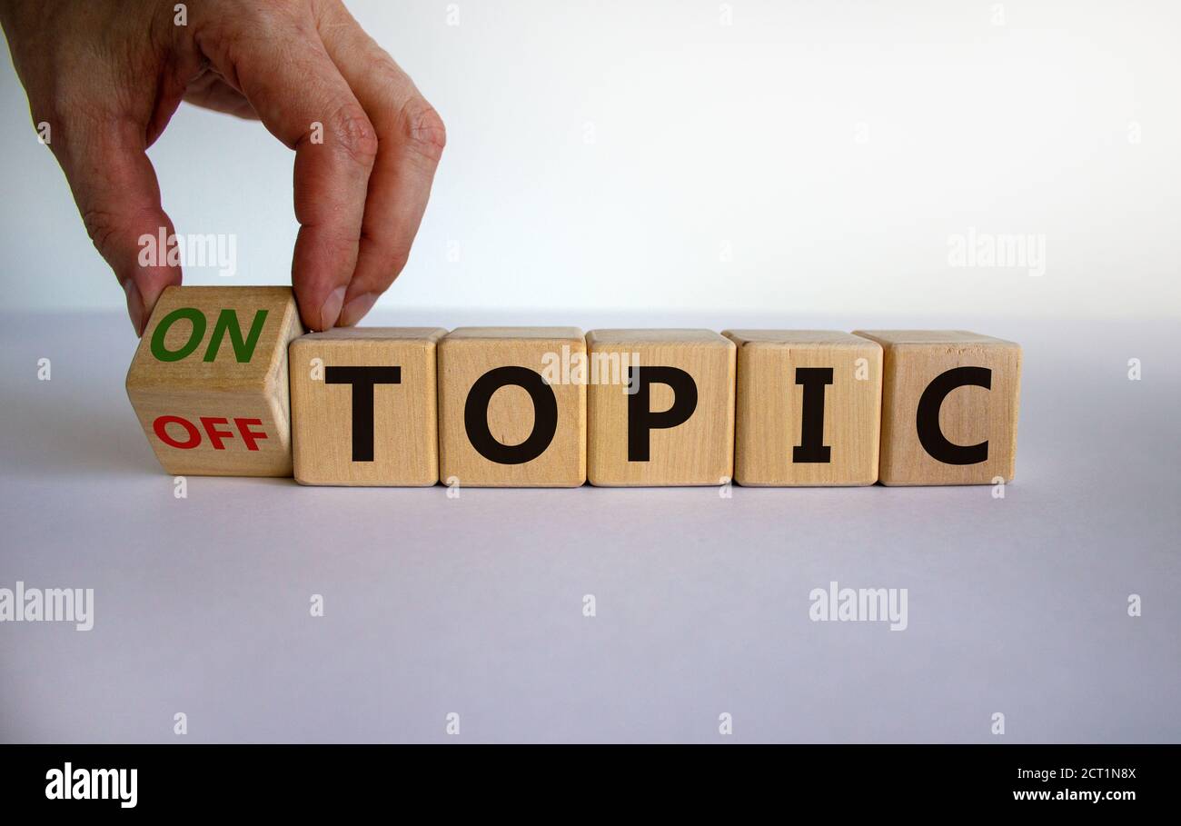 Hand turns a cube and changes the expression 'off topic' to 'on topic ...