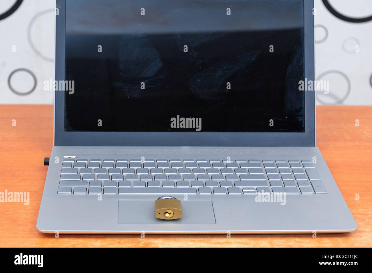 a locked padlock on a laptop mouse pad Stock Photo - Alamy