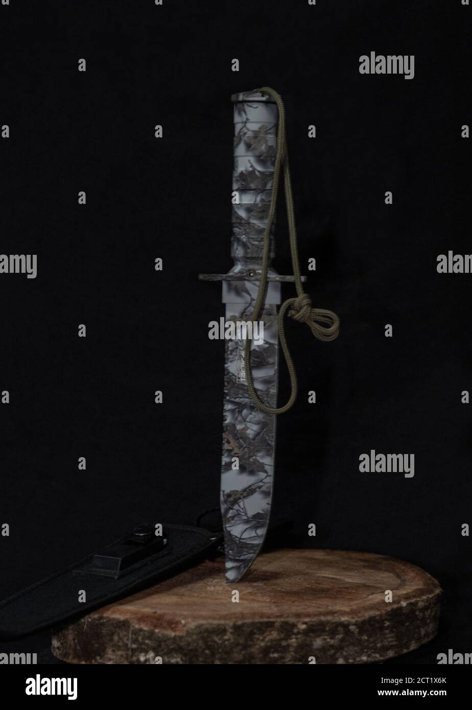 Vertical shot a patterned knife stuck into a stump Stock Photo - Alamy