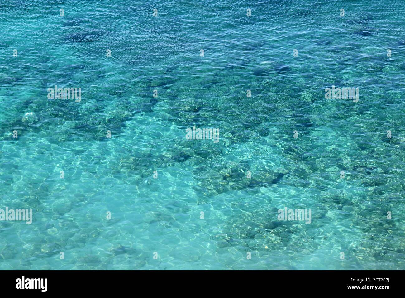 Azure water texture, transparent sea surface with a rocky bottom ...