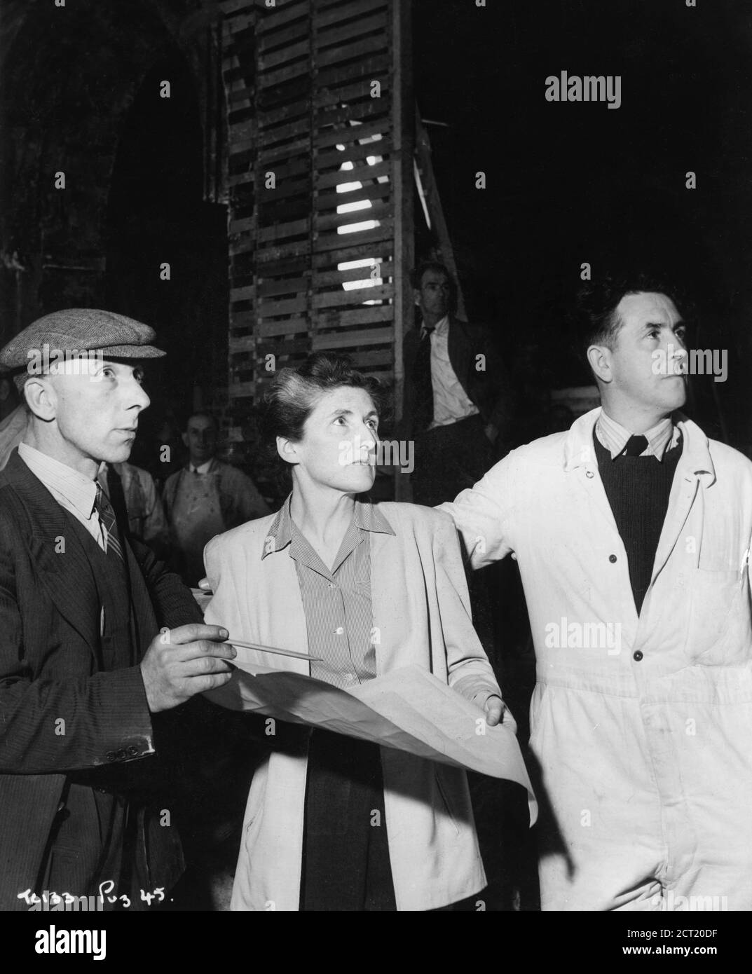 Art Director CARMEN DILLON (centre) on set candid with film crew during filming of HAMLET 1948 ...