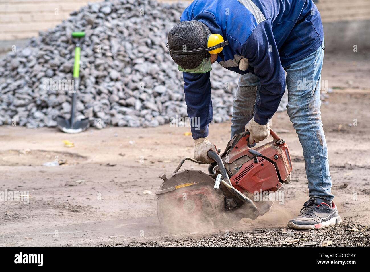 Construction worker in safety glasses and noise-canceling headphones at ...