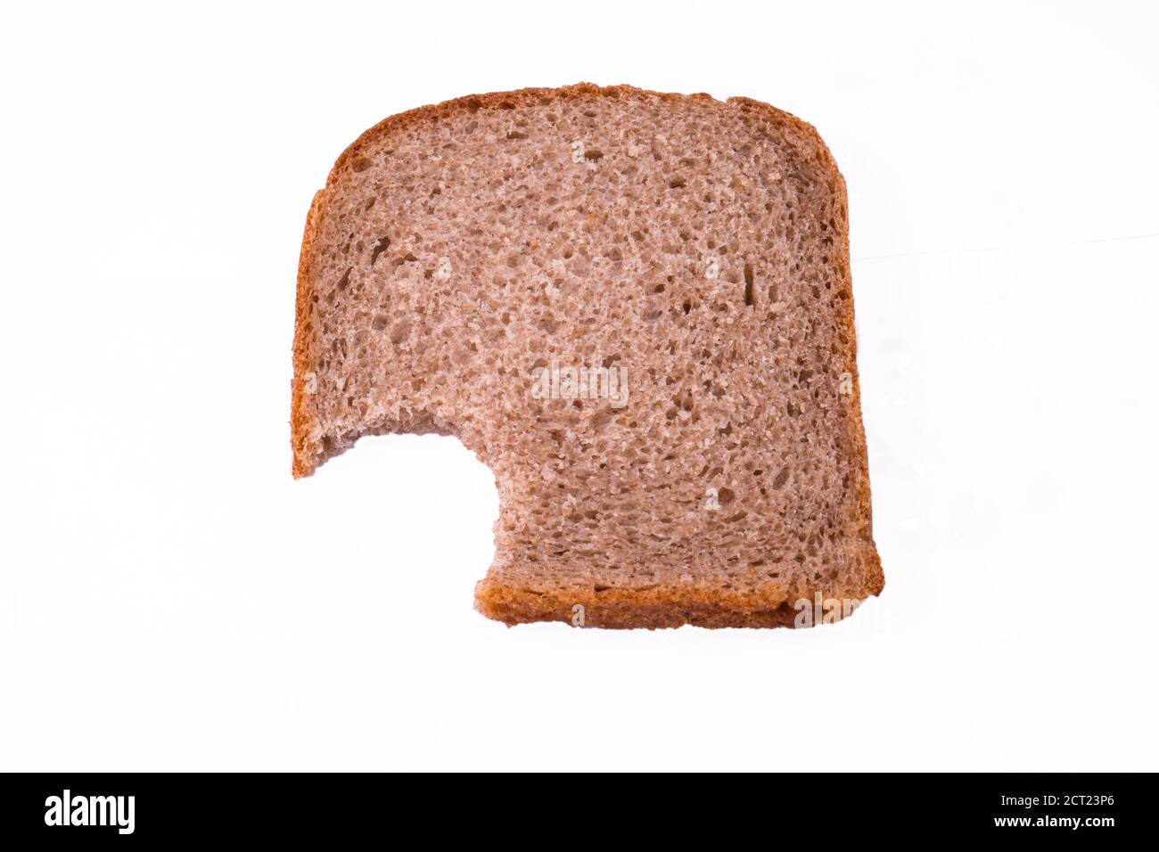 A slice of dark bread, with bite marks, from a mixture of wheat and rye ...
