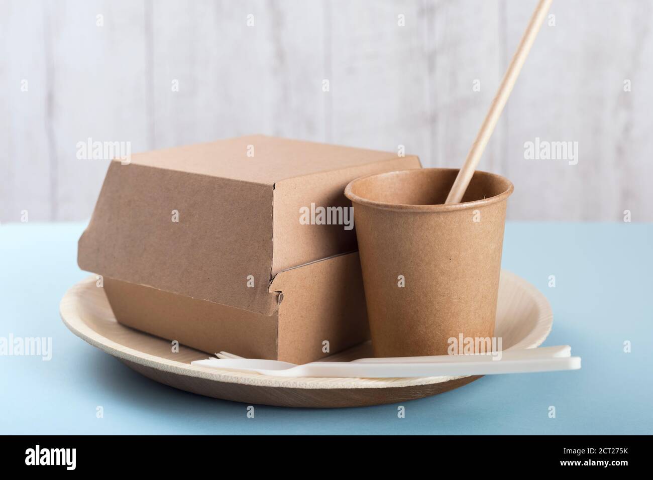 Biodegradable plate, cup, burger box and cutlery on light blue ...