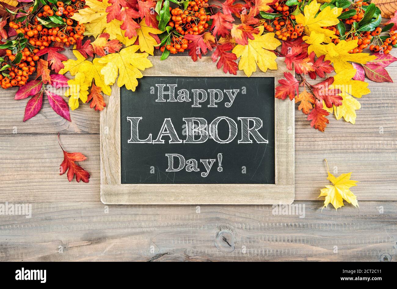 Happy Labor Day! Autumn background with colorful leaves and chalkboard ...