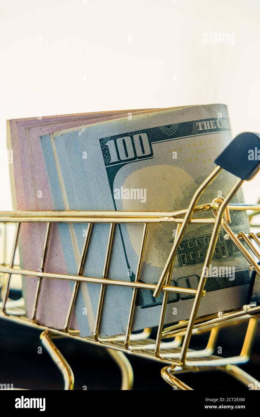 Supermarket grocery push cart for shopping with bundle of dollars money ...