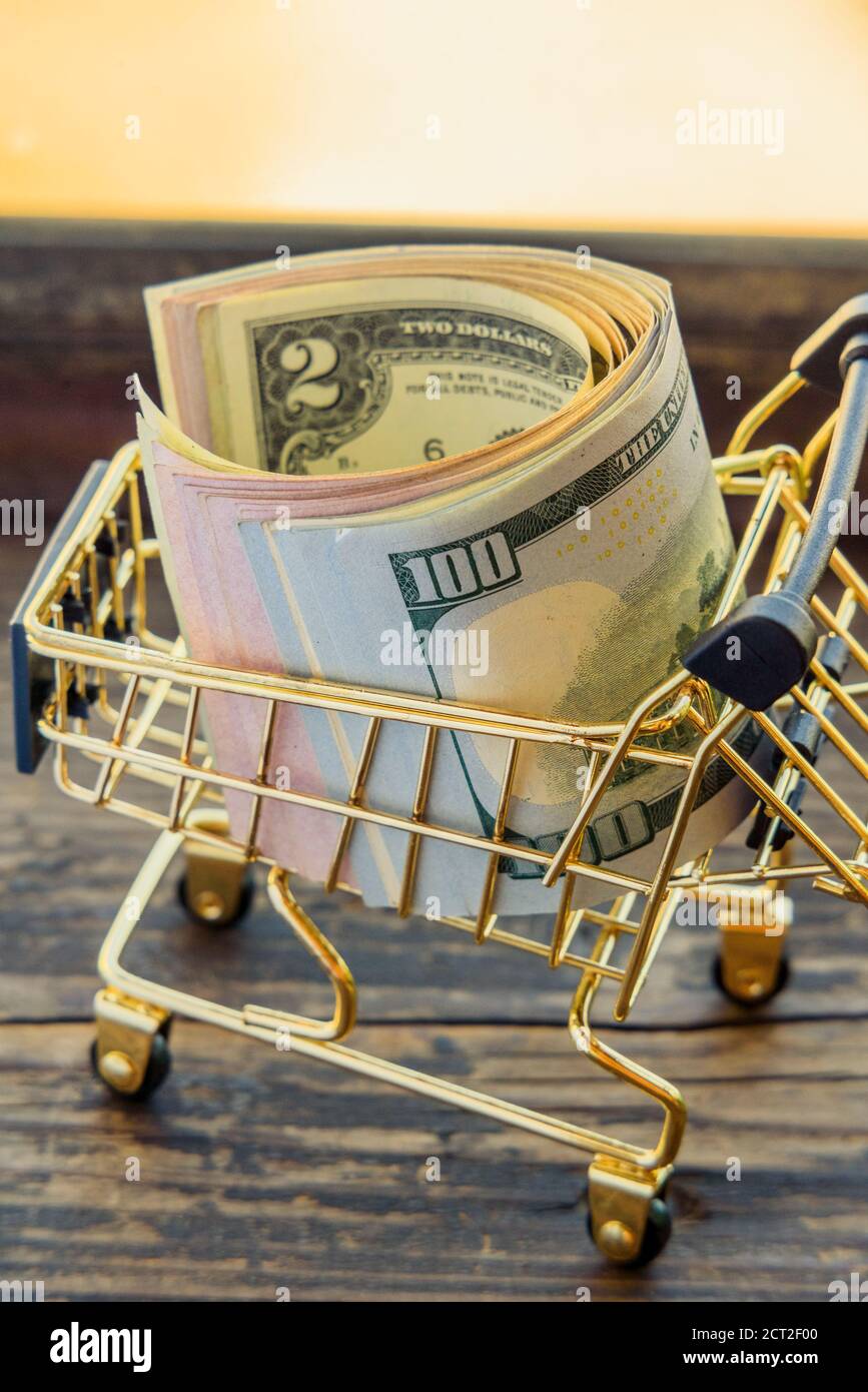 Supermarket grocery push cart for shopping with bundle of dollars money ...