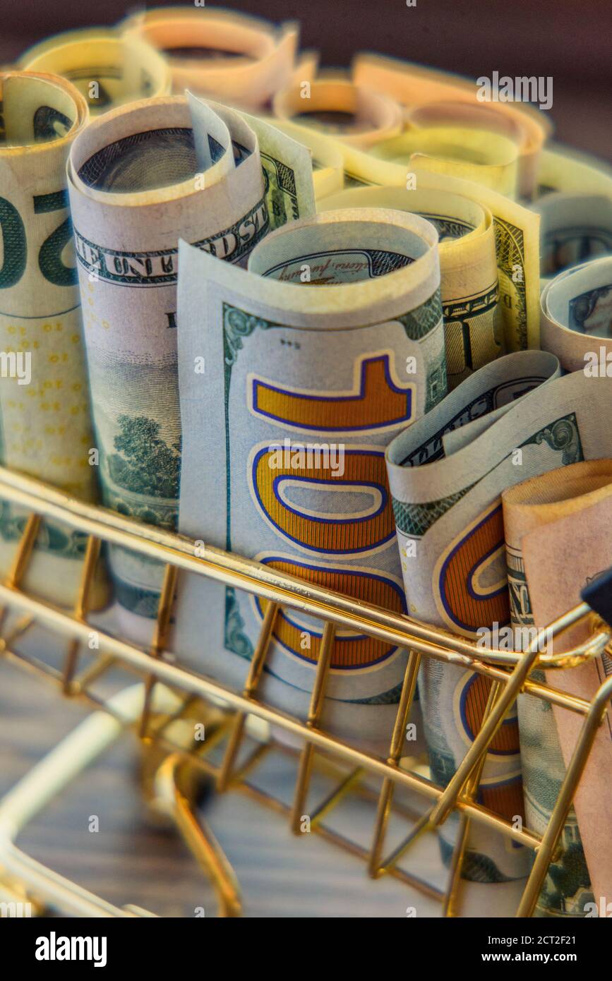 Supermarket grocery push cart for shopping with bundle of dollars money ...